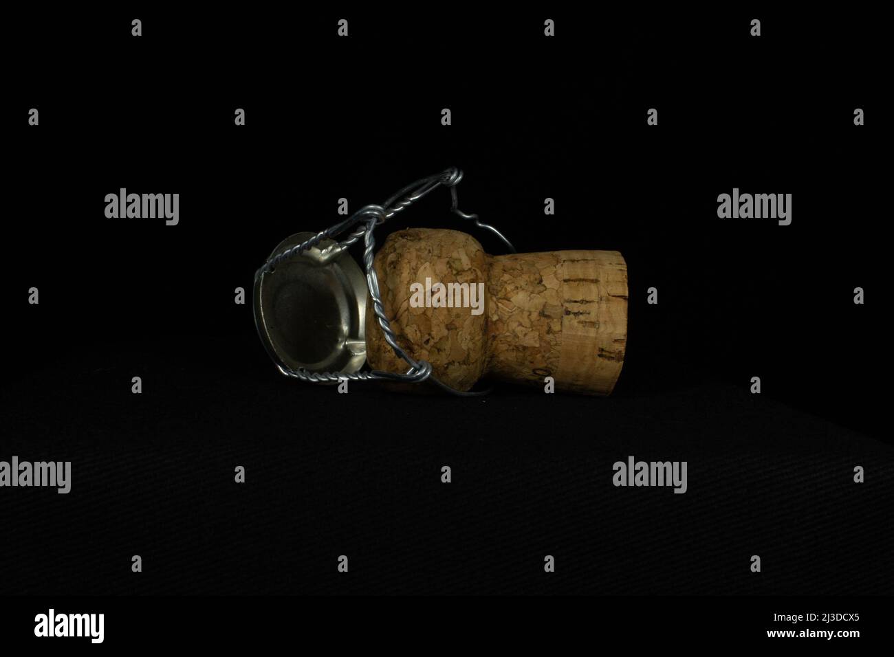 sparkling wine cork and wire cage isolated on a black background Stock ...