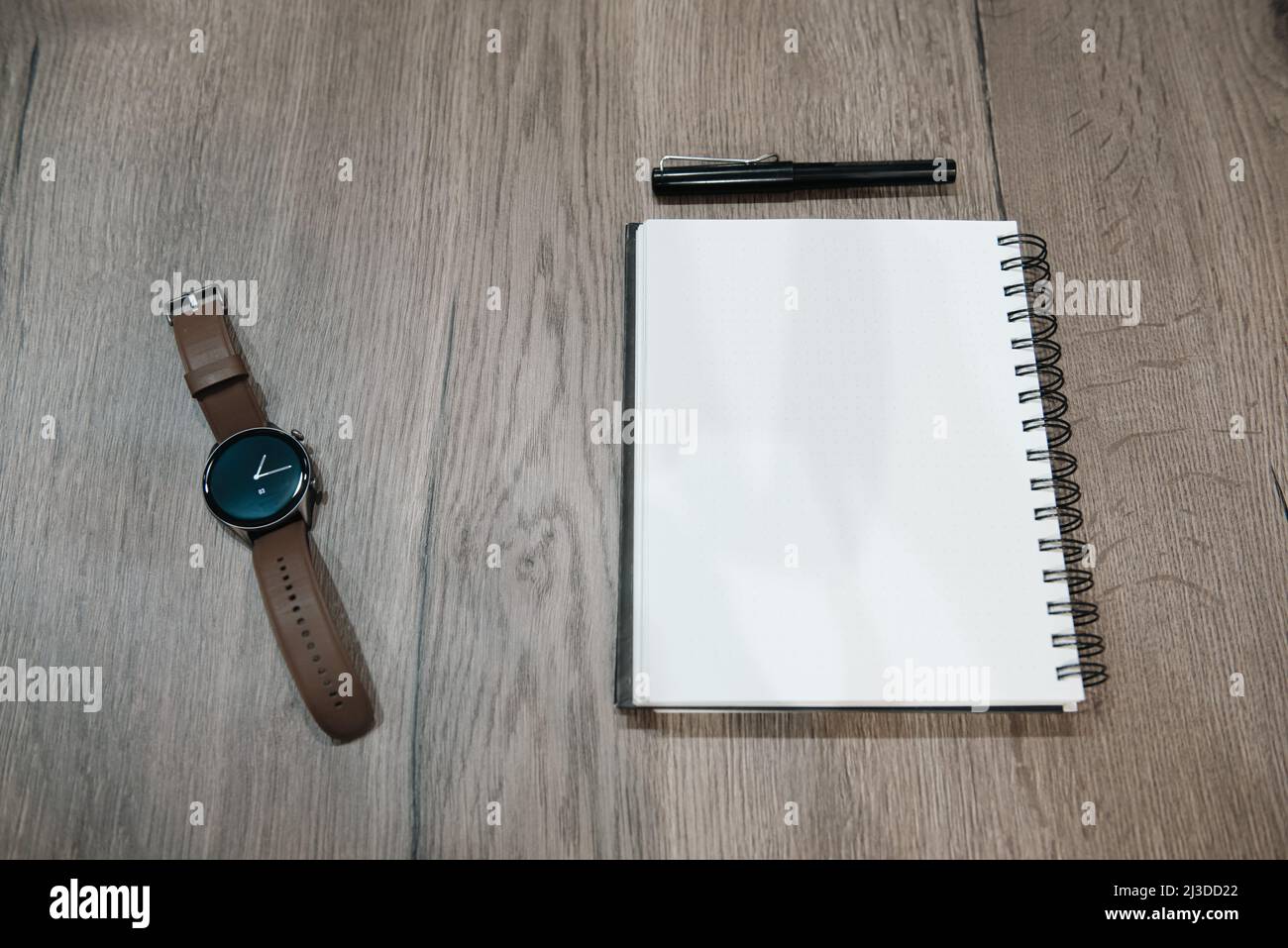classic smart watch on a rustic table with space for text on white ...