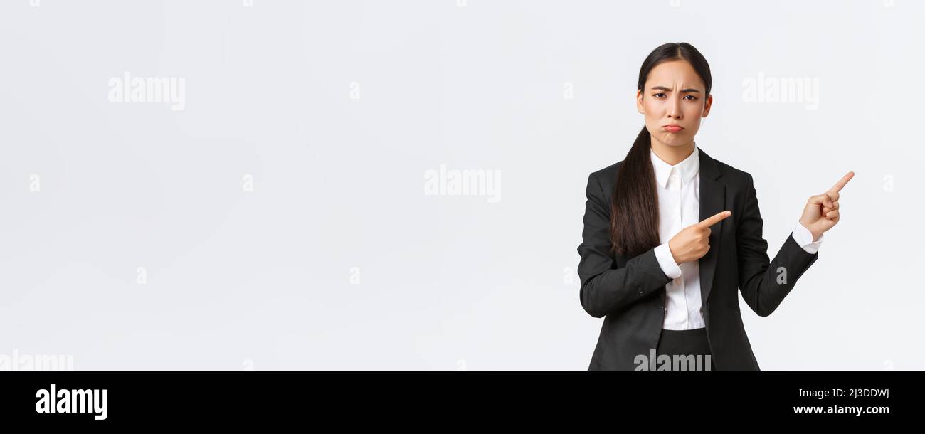 Disappointed or jealous female asian entrepreneur in suit complaining ...