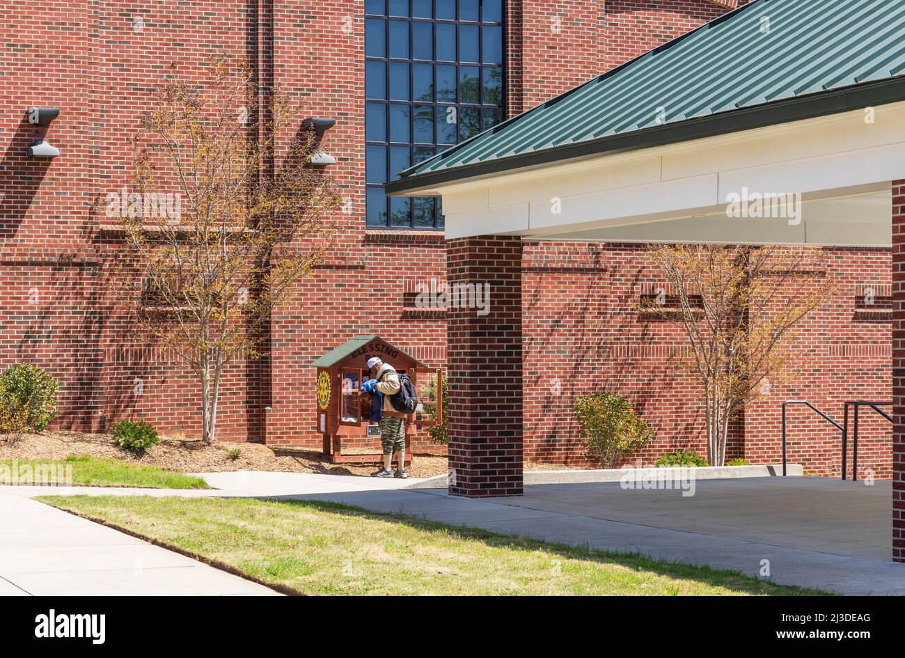 CONCORD, NC, USA-3 APRIL 2022: Man using a "Blessing Box" on the ...