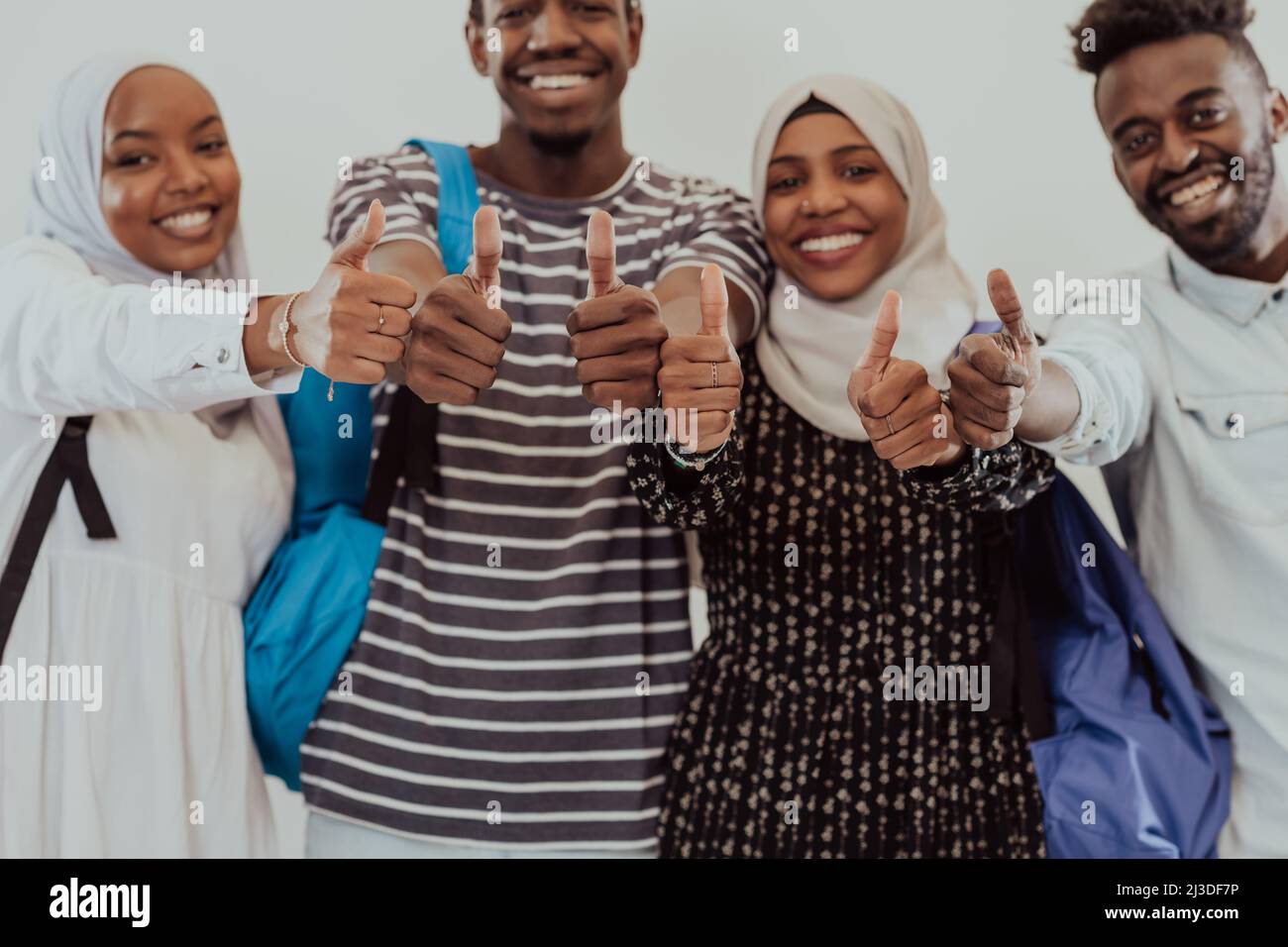 Group portrait of happy African students standing together against a ...