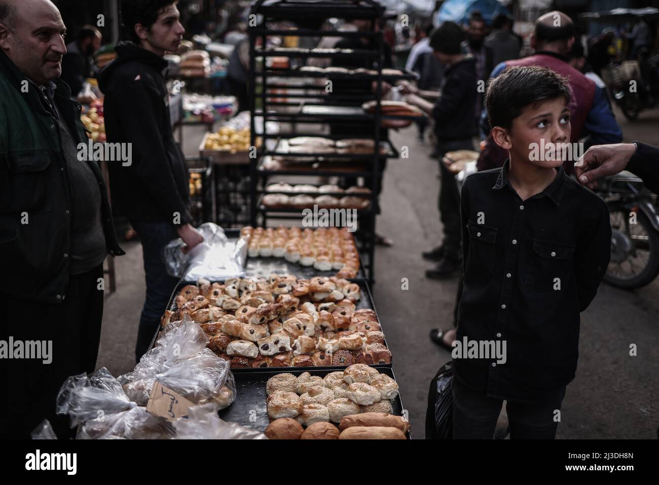 Arihah, Syria. 07th Apr, 2022. A Syrian boy waits to buy baked goods at ...
