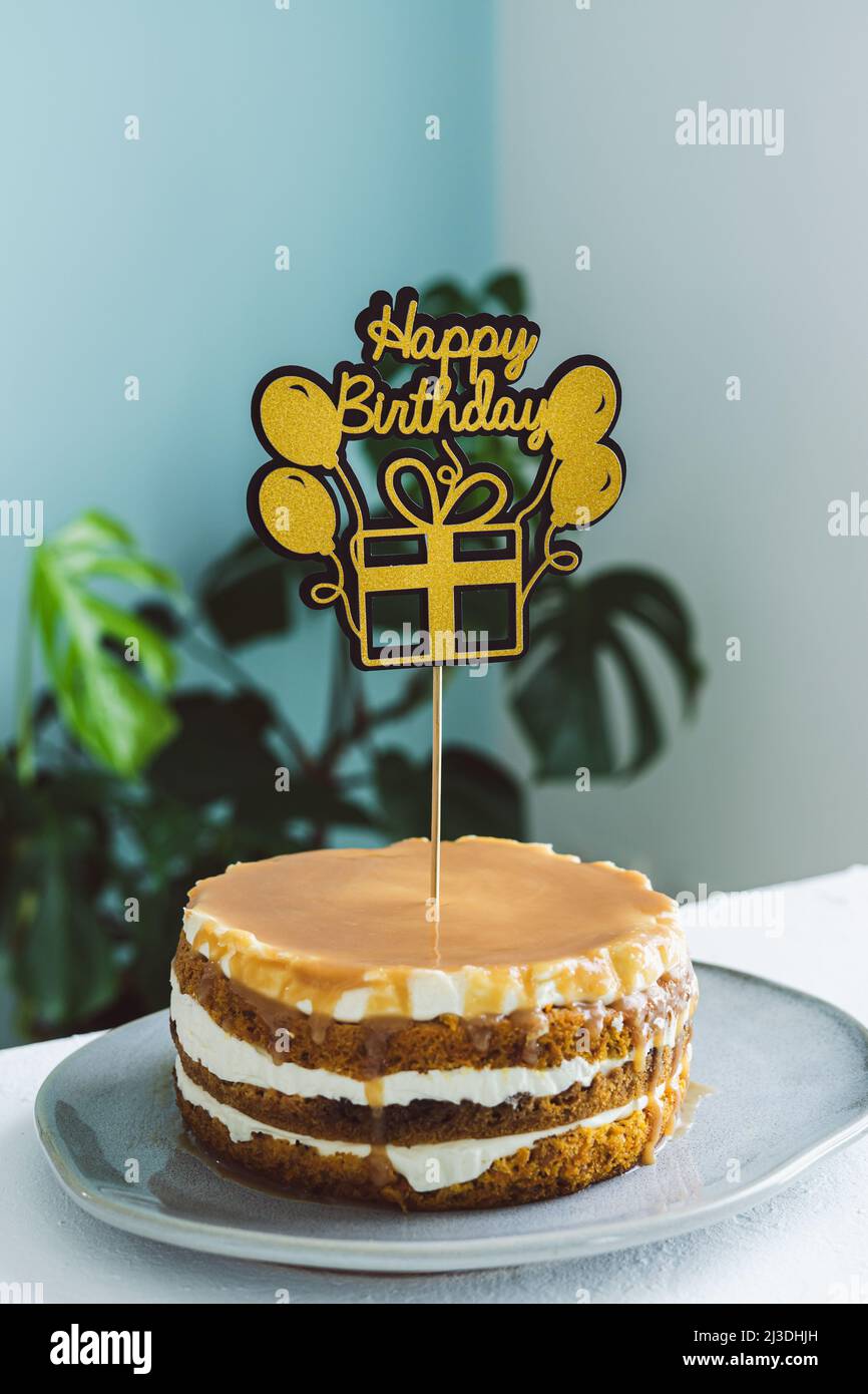 Cake with Birthday topper. Copy space. Blurred background. Vertical ...