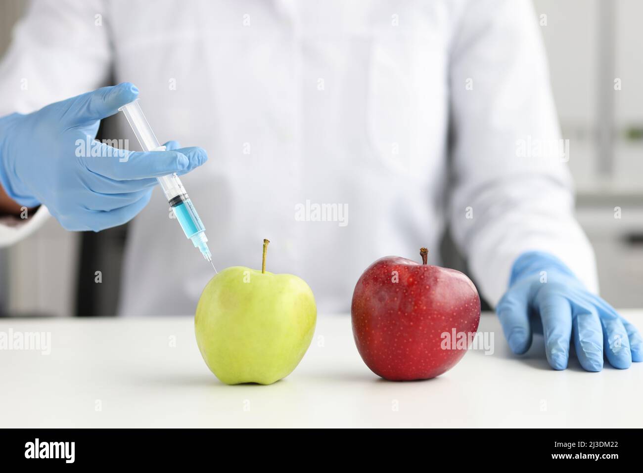 Scientist makes injection in apple in laboratory Stock Photo - Alamy