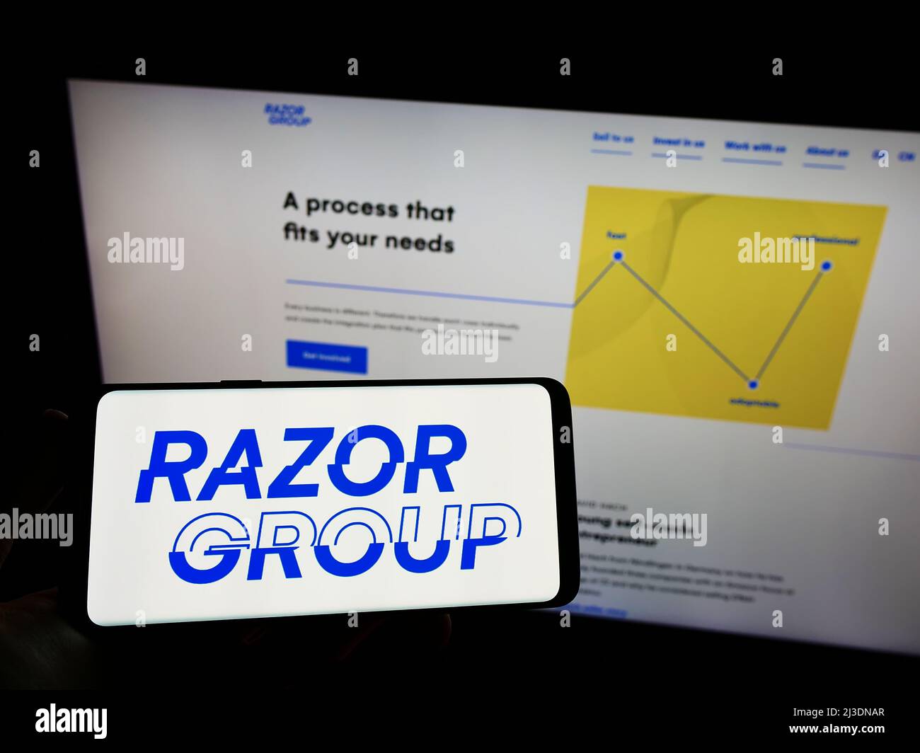 Person holding mobile phone with logo of German e-commerce company ...