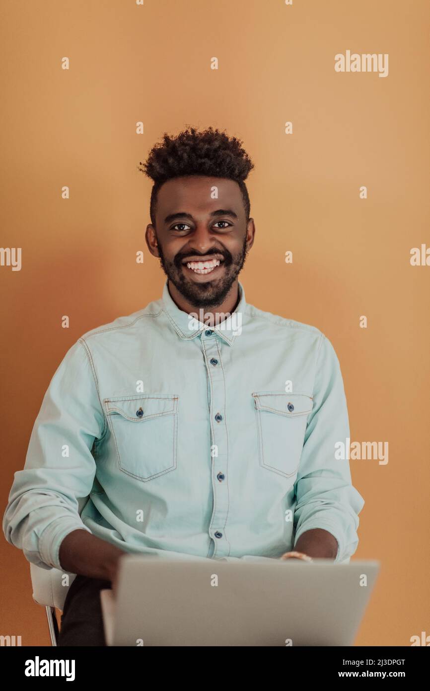 African student using laptop computer to study and make business ...