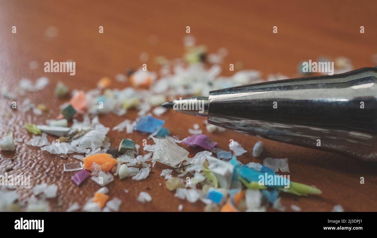 Macro shot of microplastics on witt pencil for size comparison. Concept ...