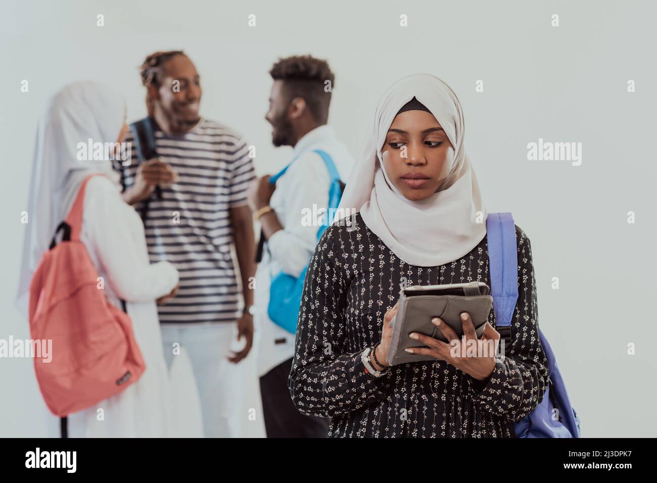 African female student with group of friends in background wearing ...