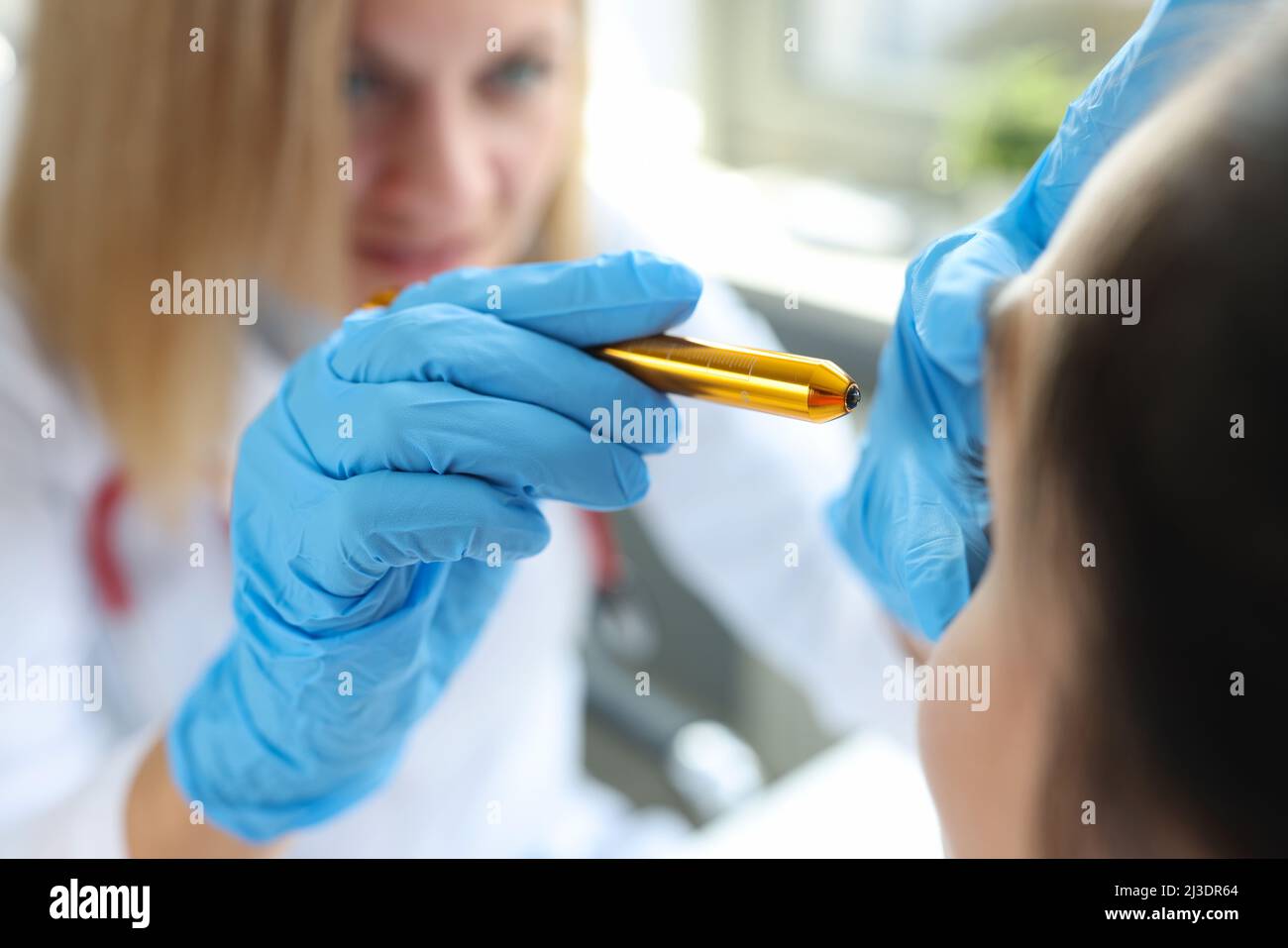 Doctor ophthalmologist shines light in patient eyes Stock Photo - Alamy