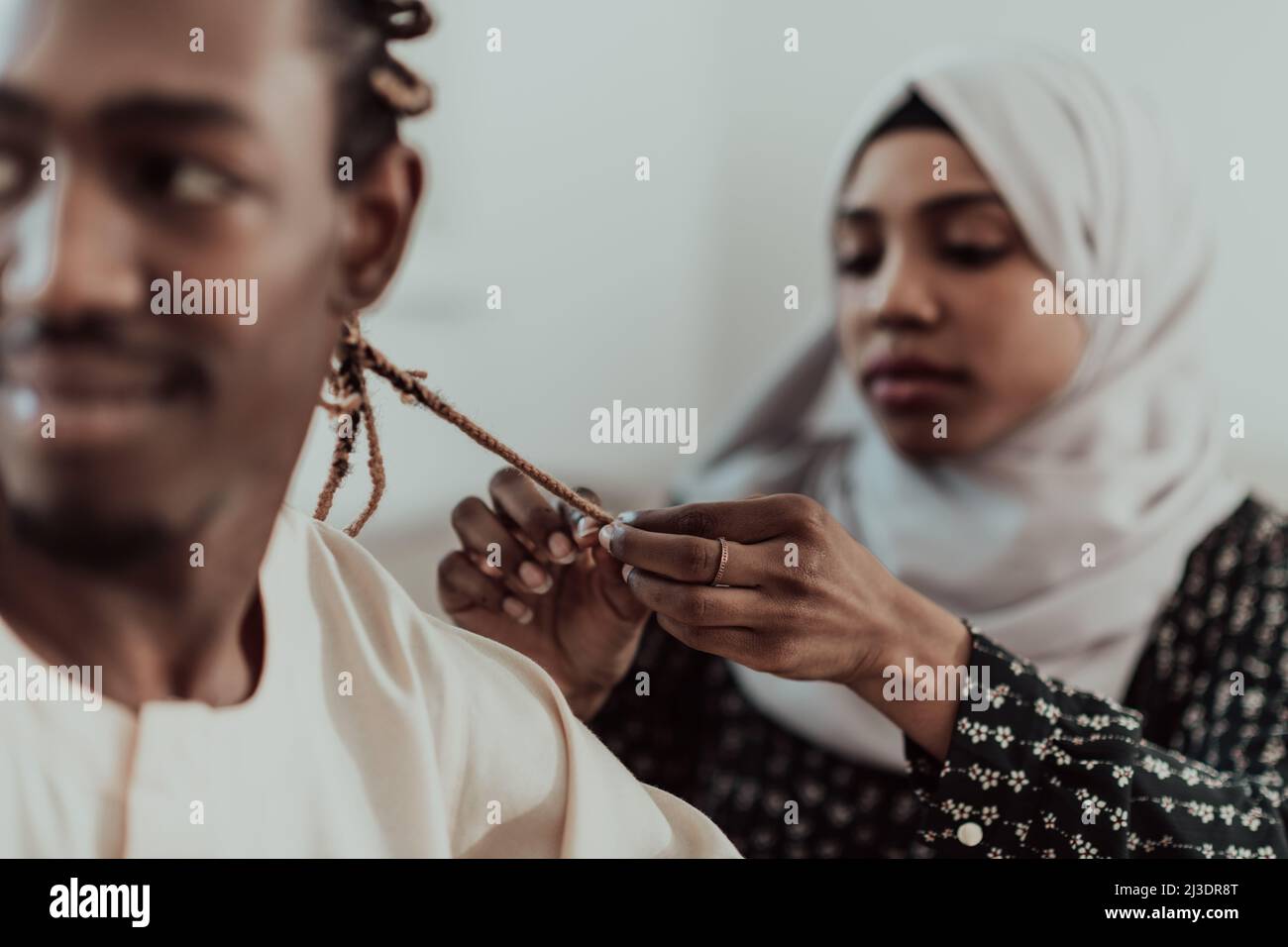 A young Muslim couple has a romantic time at home while the woman makes ...