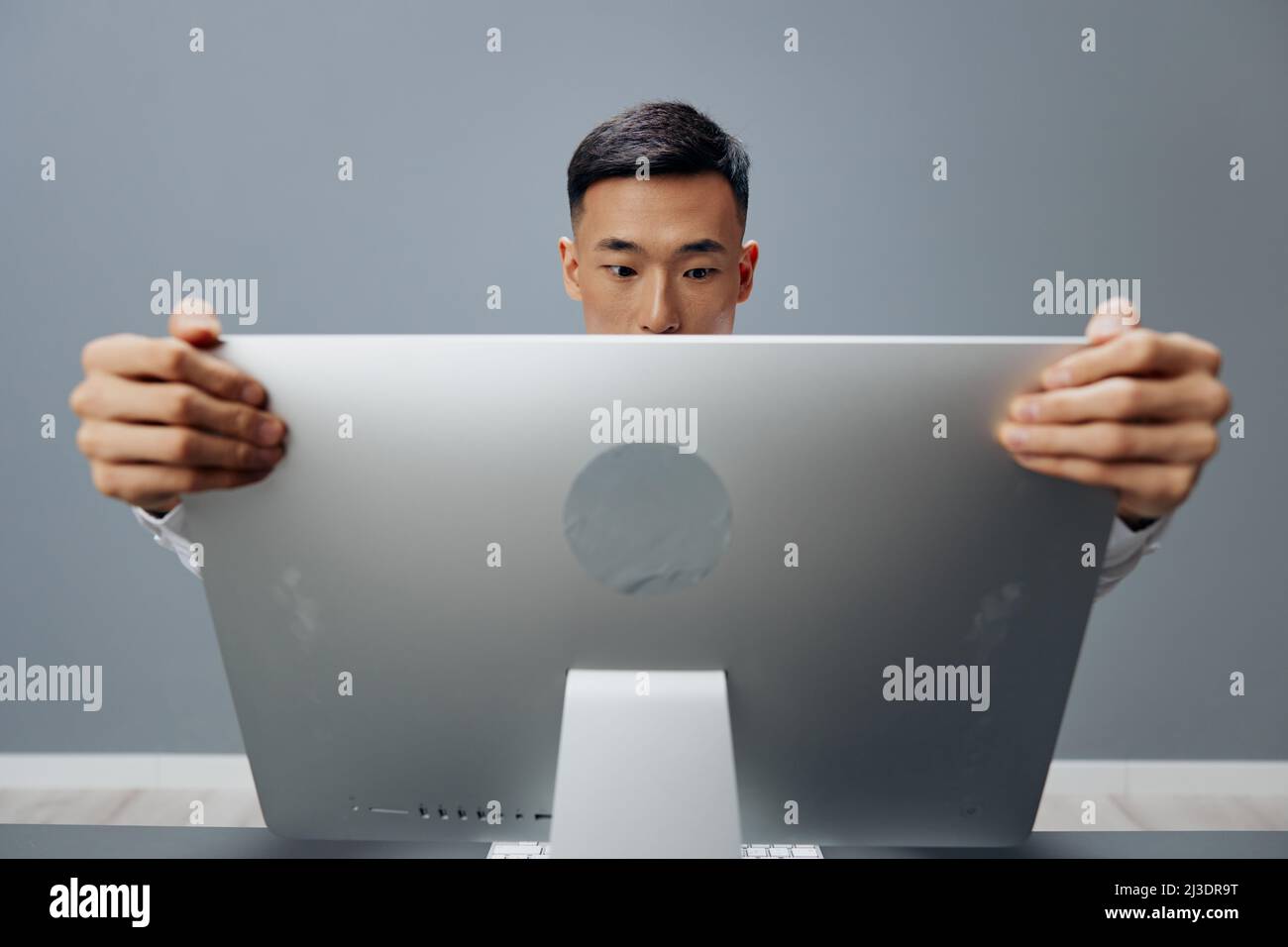 man holding on to the monitor emotions office isolated background Stock ...