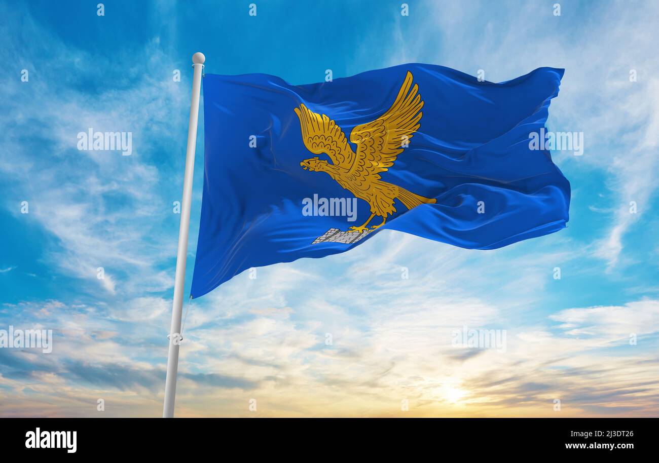 flag of Friuli-Venezia Giulia, Italy at cloudy sky background on sunset ...