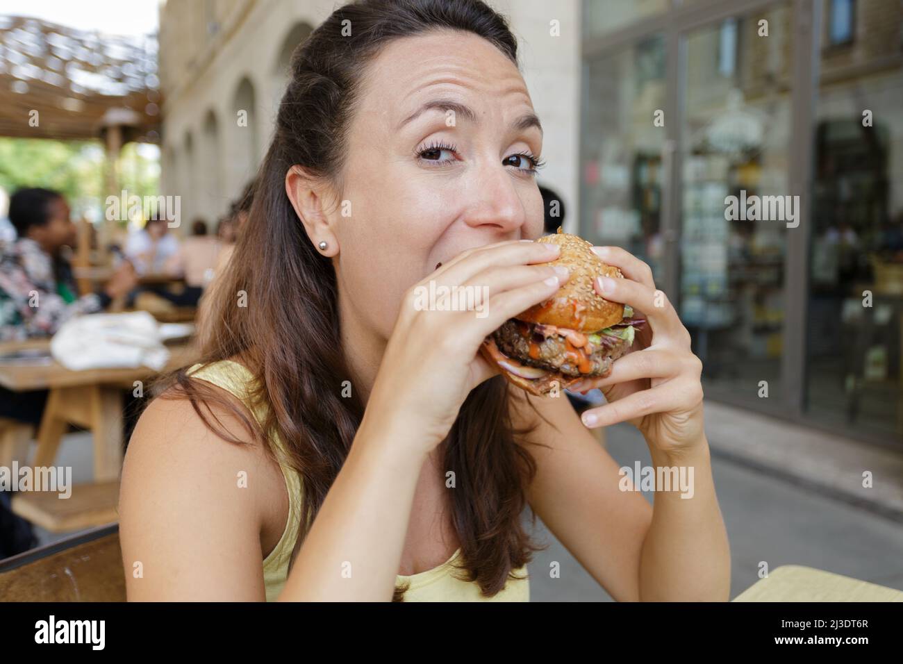 Woman enjoying big bite hi-res stock photography and images - Alamy