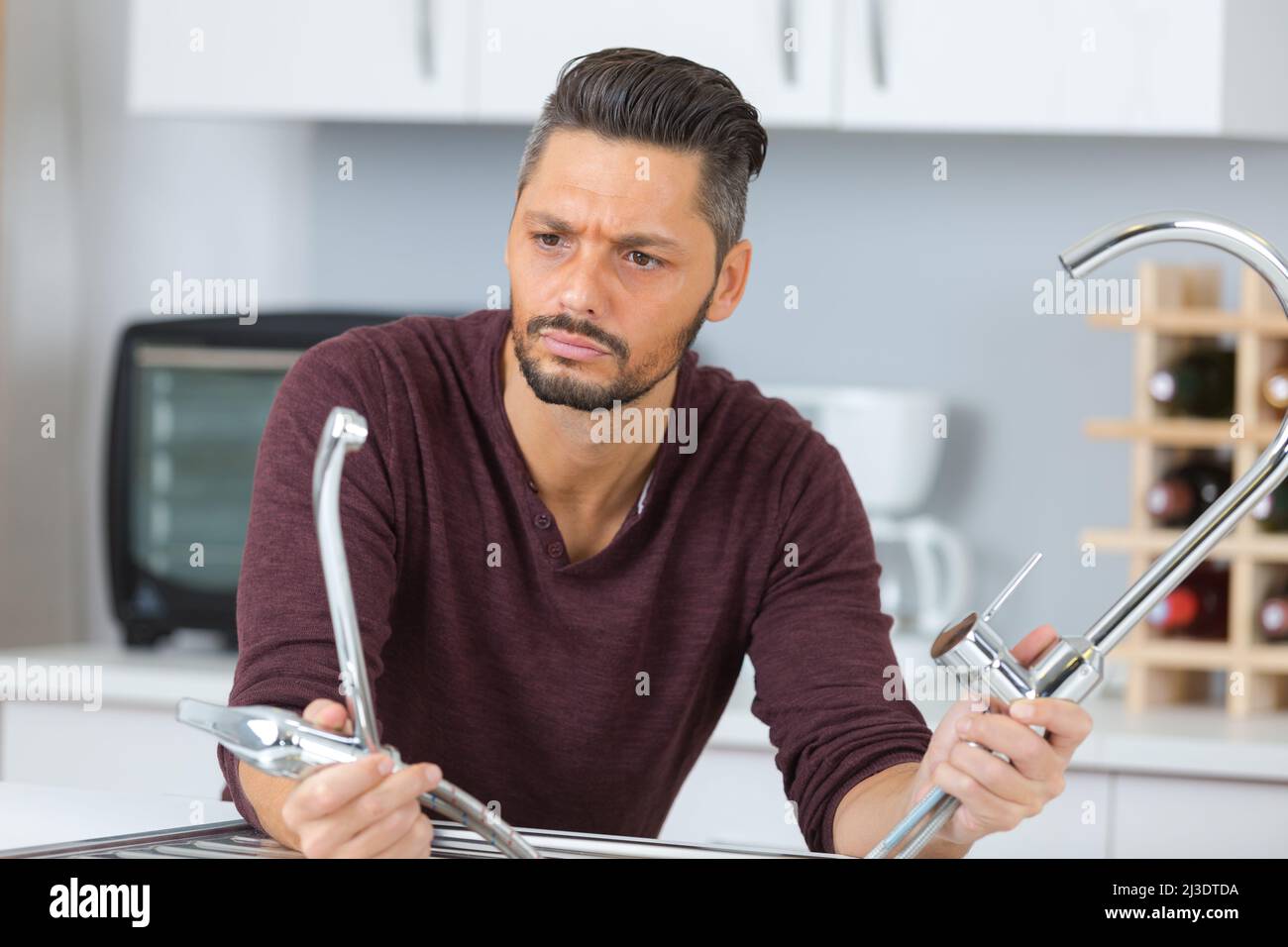 young handsome man with flexible hose and tap Stock Photo - Alamy