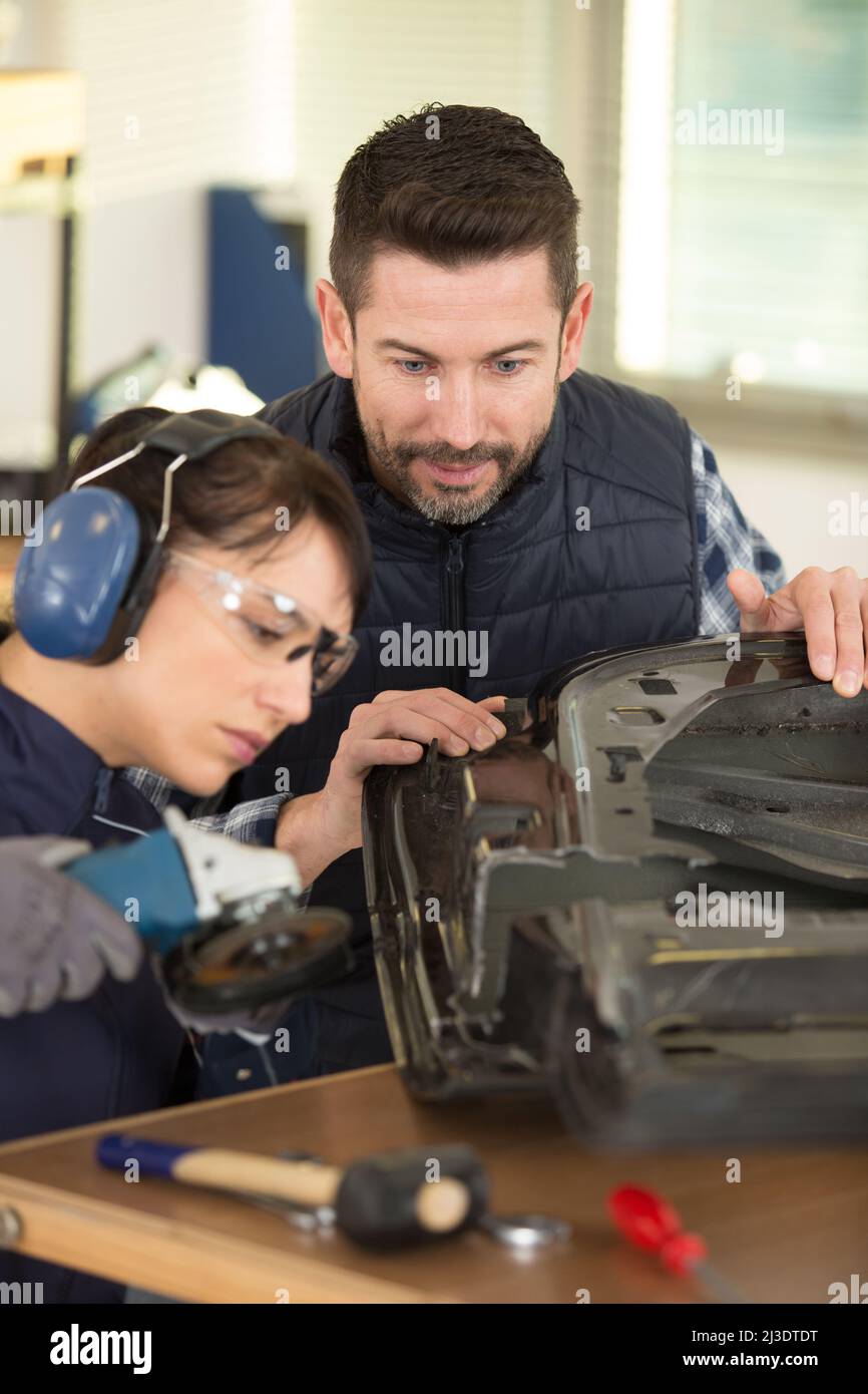 Male mechanics working together repairing hi-res stock photography and ...
