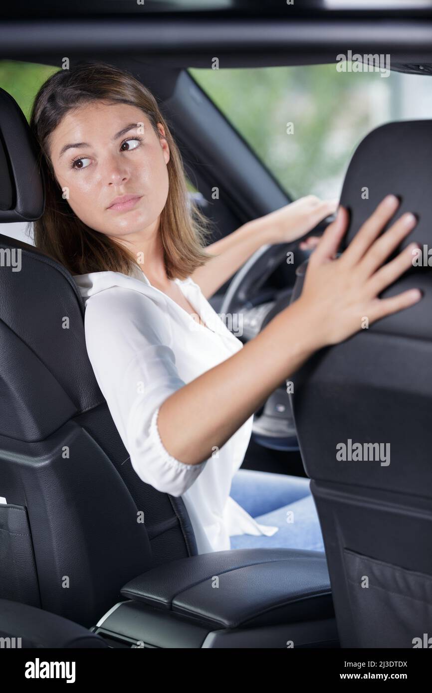 young woman driver turning back Stock Photo - Alamy