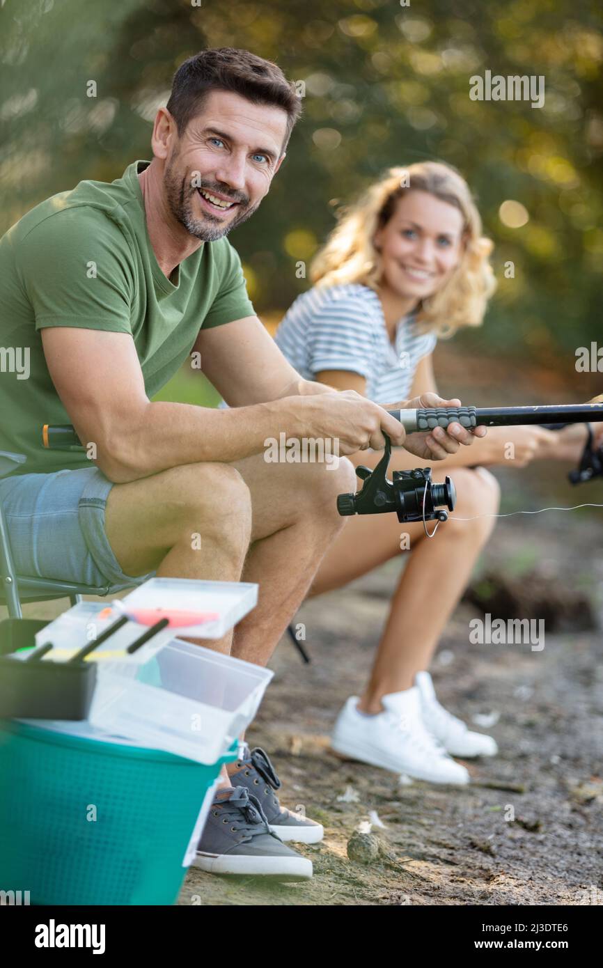 couple fishing on a pontoon Stock Photo - Alamy