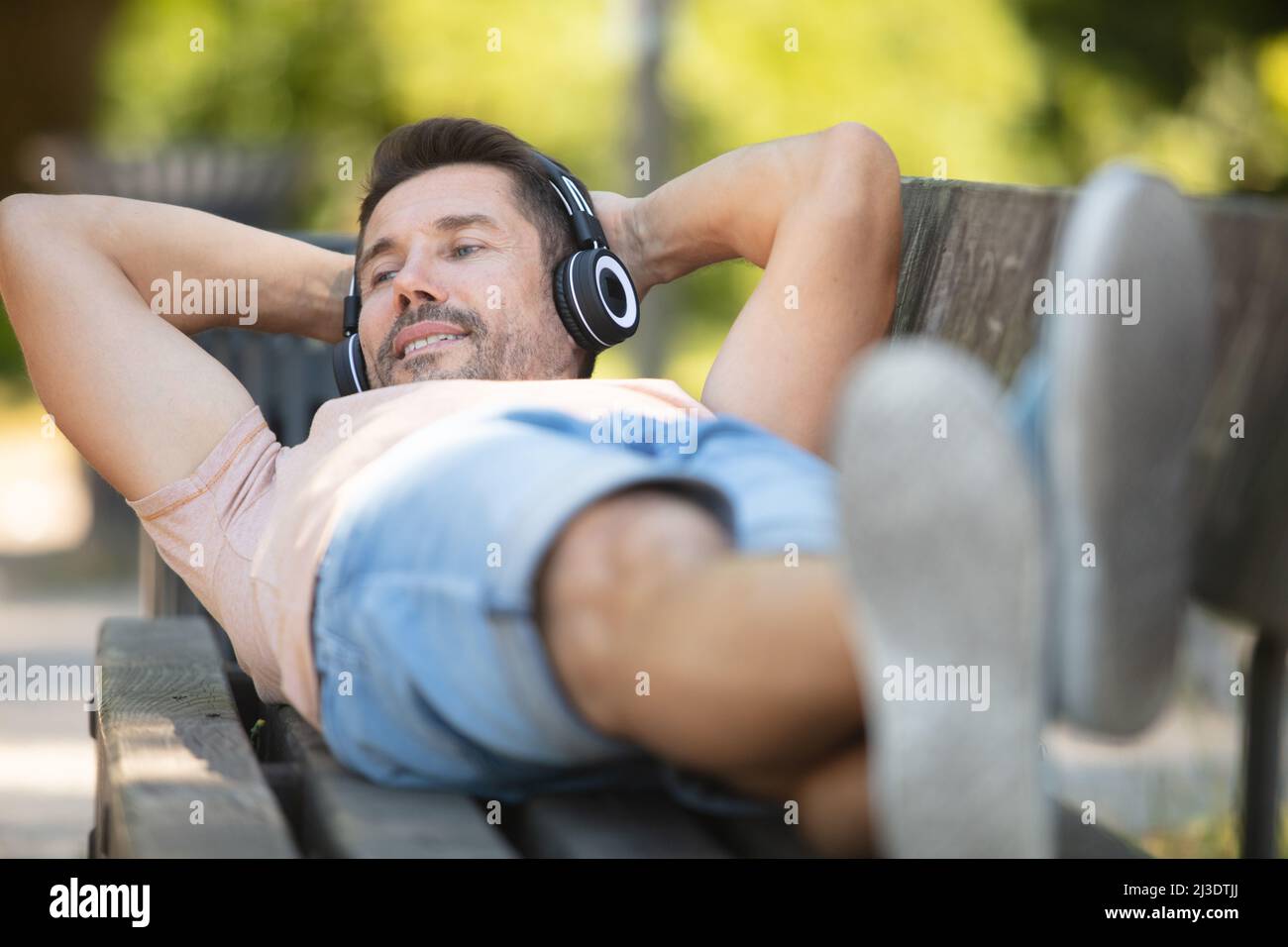 Man laying on a bench hi-res stock photography and images - Alamy