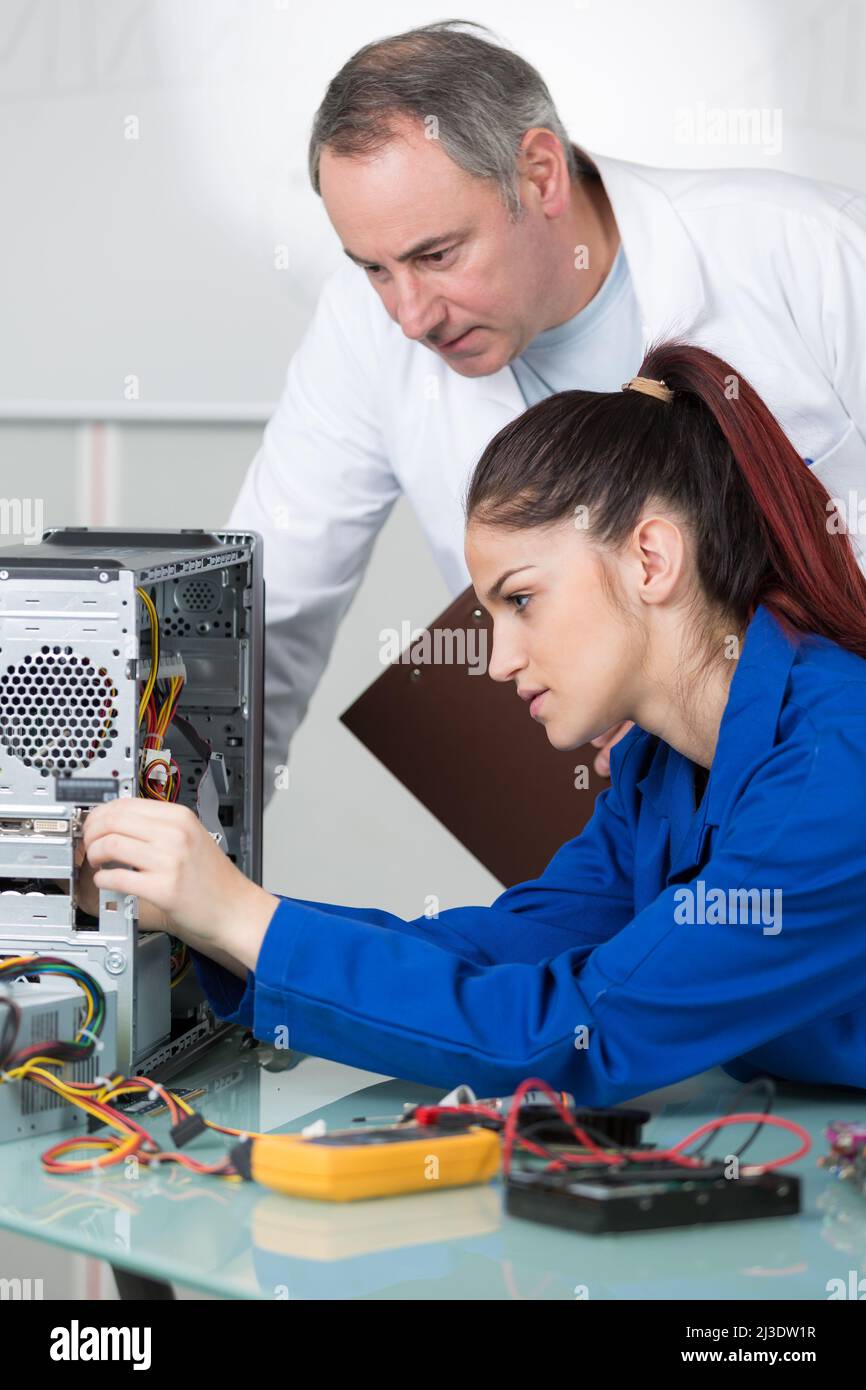 teacher showing student on whiteboard how to fix a computer Stock Photo ...
