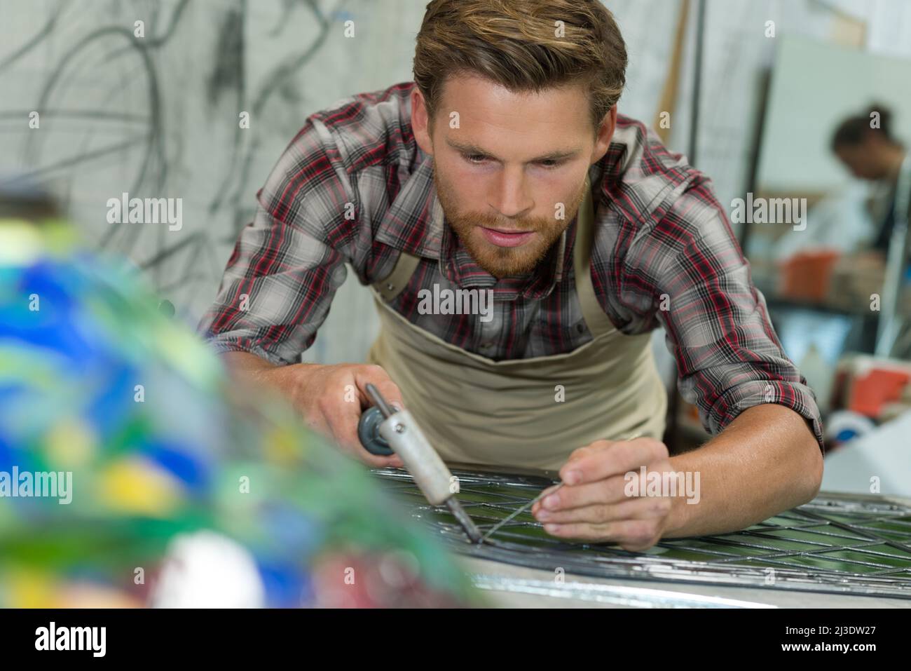 a stained glass window worker Stock Photo - Alamy