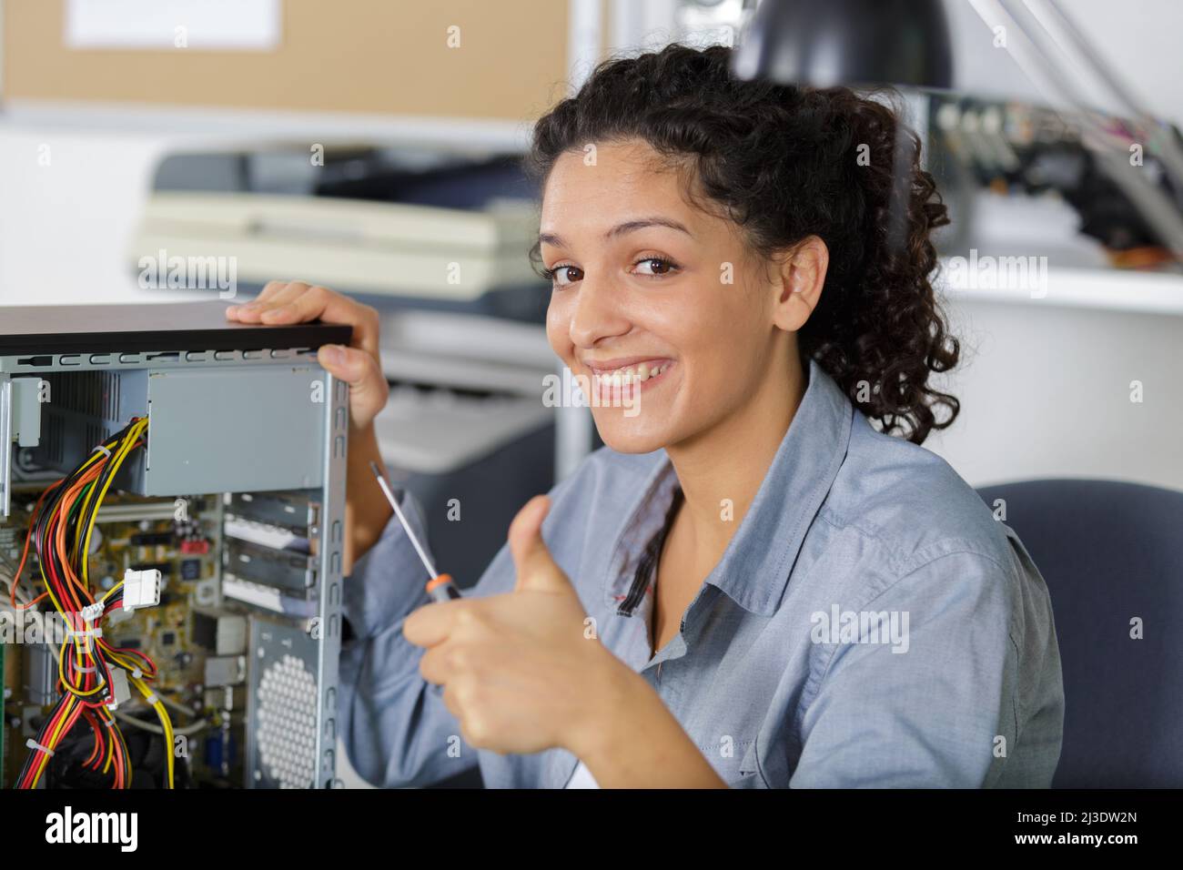 happy female pc technician showing her thumb-up Stock Photo - Alamy