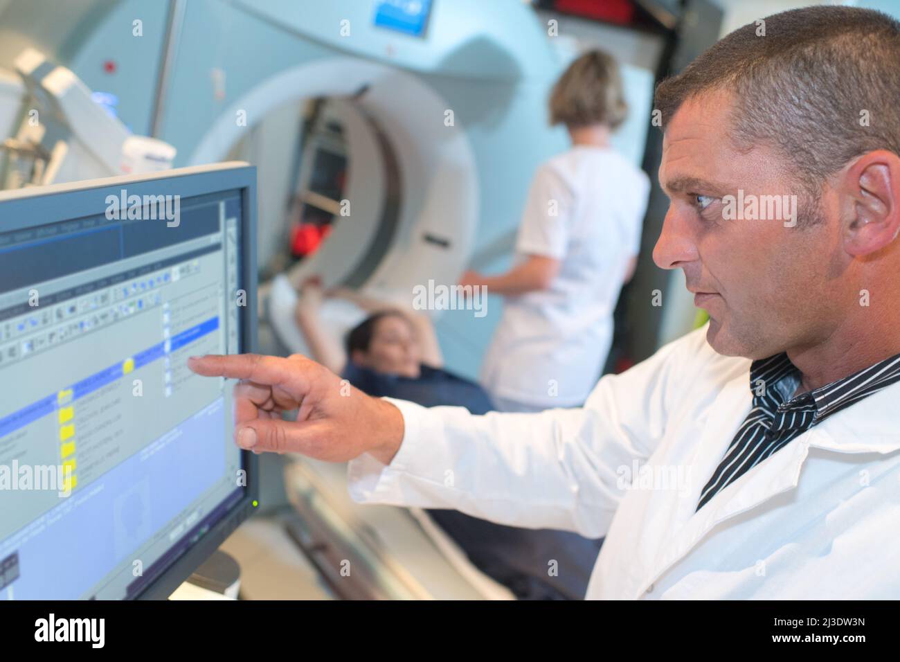 doctor checking screen before mri scan Stock Photo - Alamy