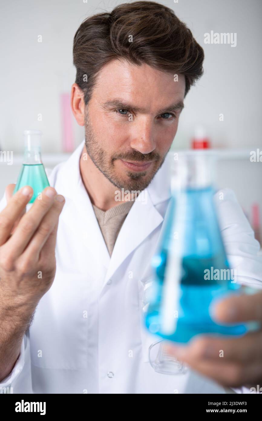 male doctor lab flasks liquid scientific research Stock Photo - Alamy