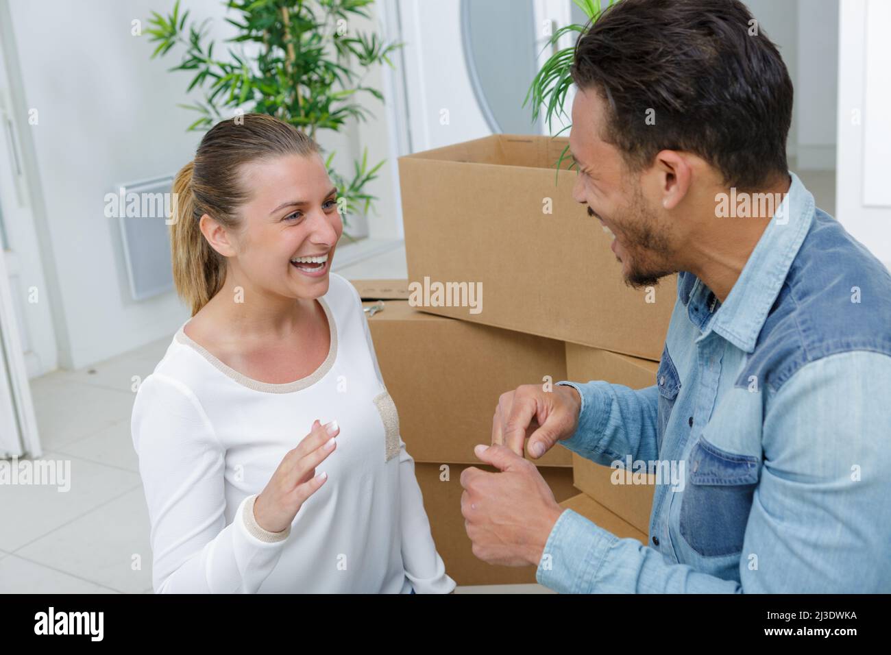 happy couple with their boxes Stock Photo - Alamy