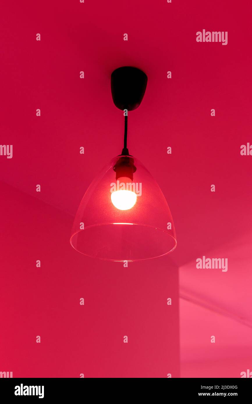 Luminary on the ceiling in the room in the red light Stock Photo - Alamy