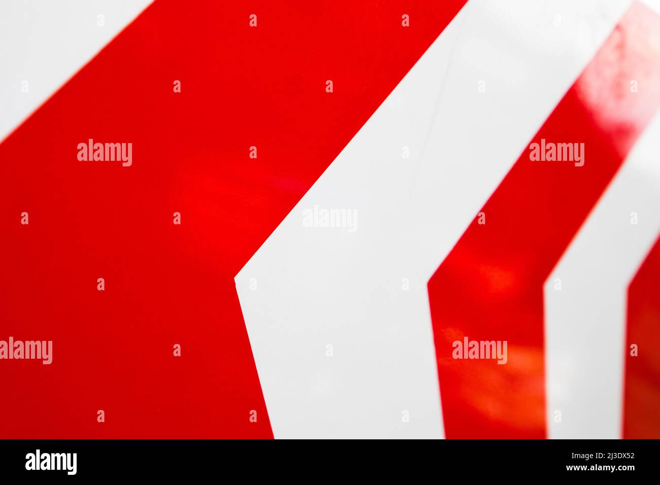 Left turn direction, red and white road sign, close up abstract ...