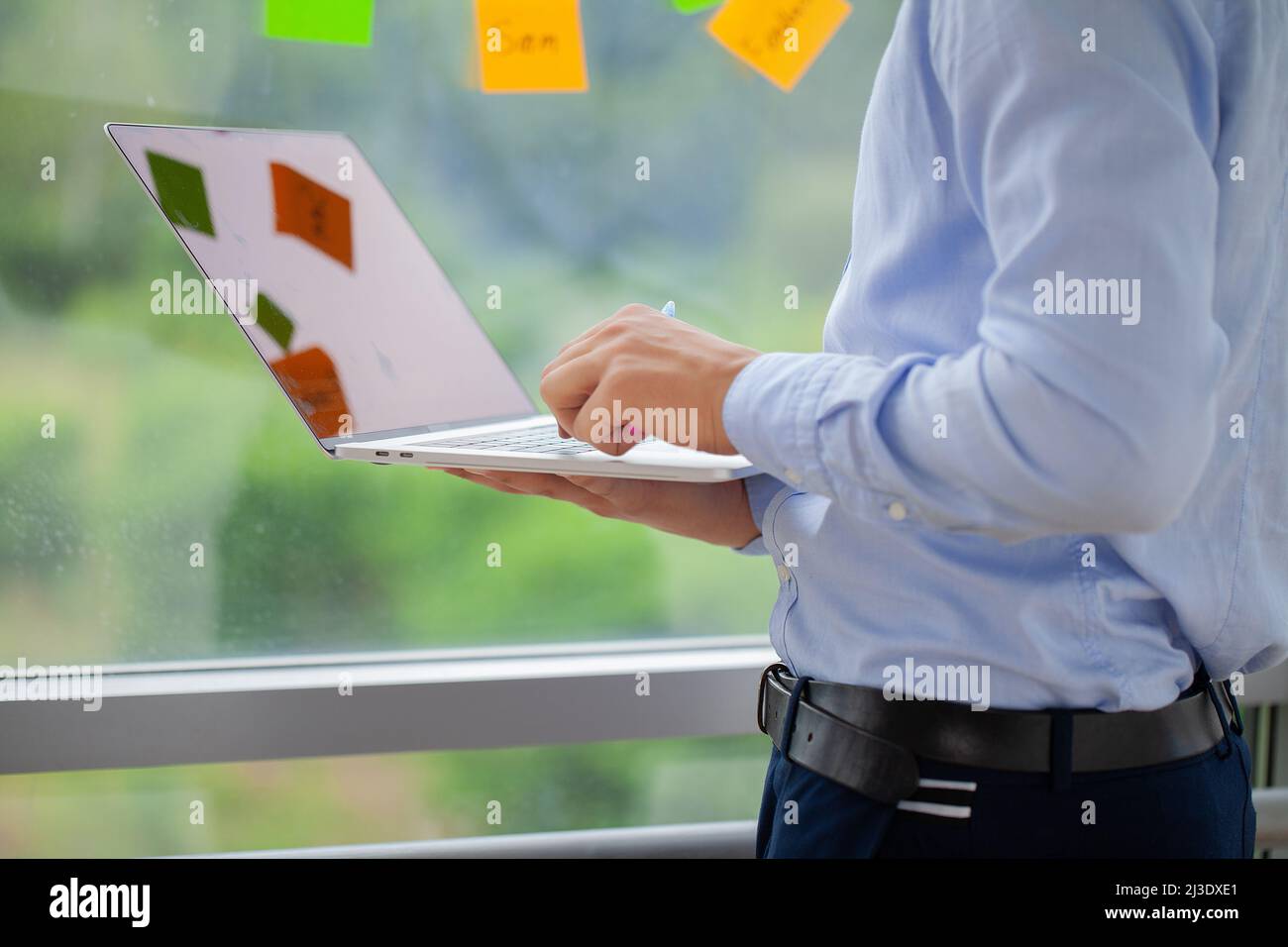 Young handsome businessman using laptop at his office Stock Photo - Alamy