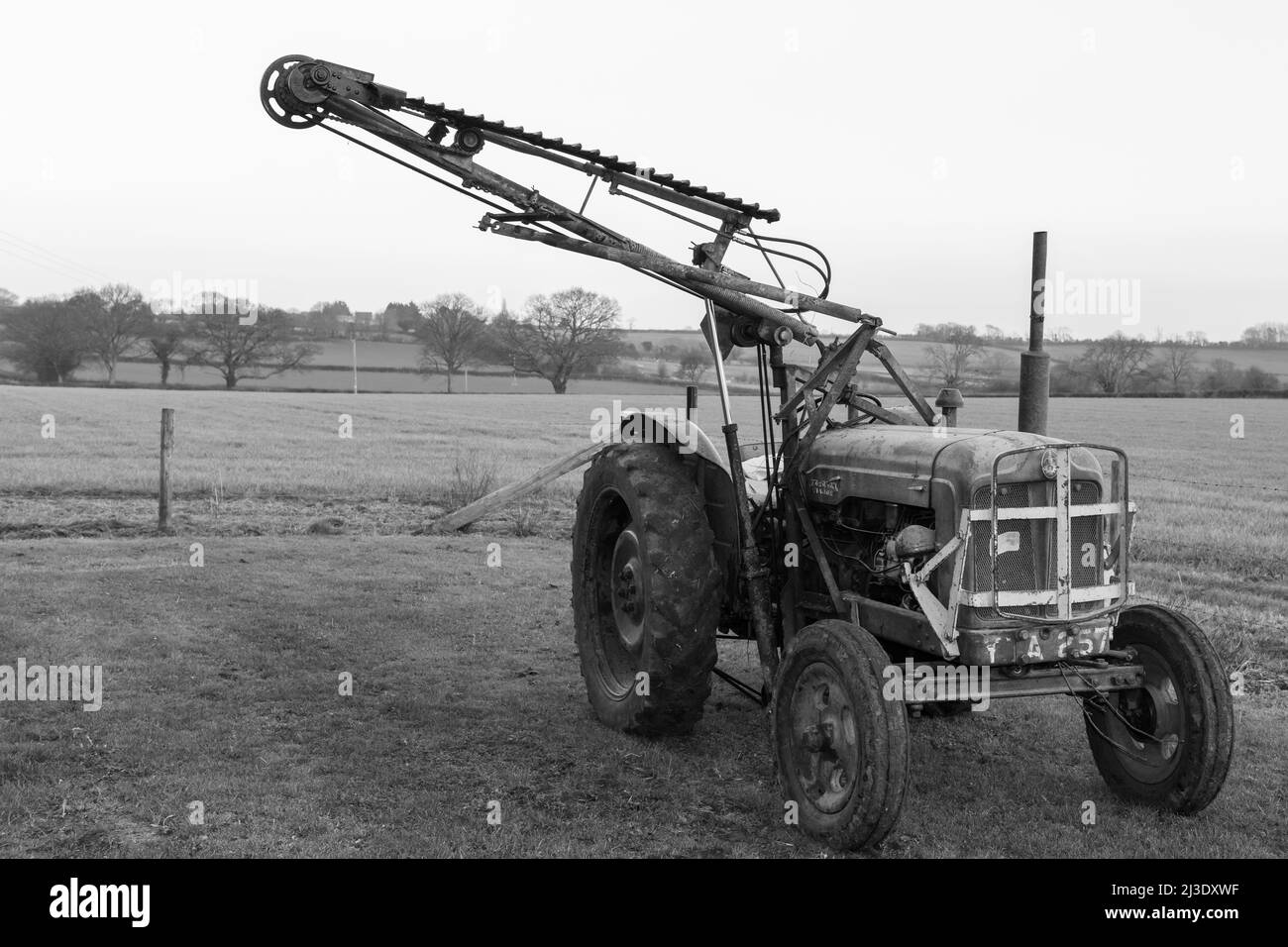 An old antique hedge trimmer mounted on a vintage tractor Stock Photo ...