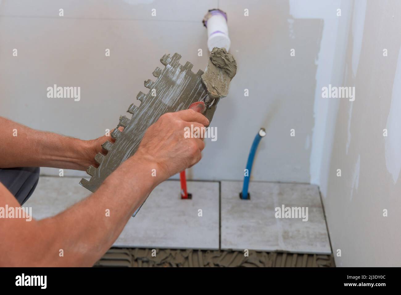 Home construction working with placing ceramic floor tiles Stock Photo ...
