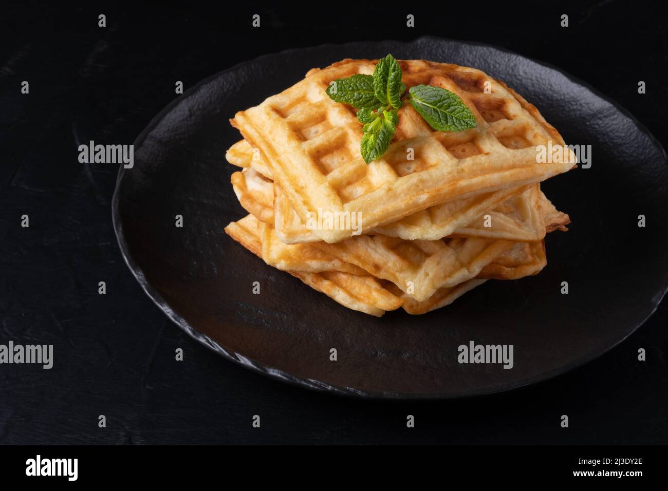 Homemade delicious belgian waffles on the black table Stock Photo - Alamy