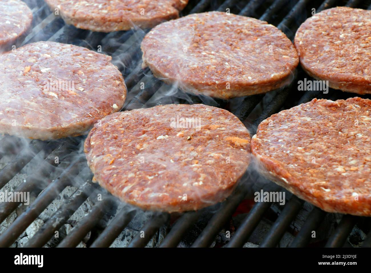 beef meat burger patty on a hot smoky barbeque grill Stock Photo - Alamy