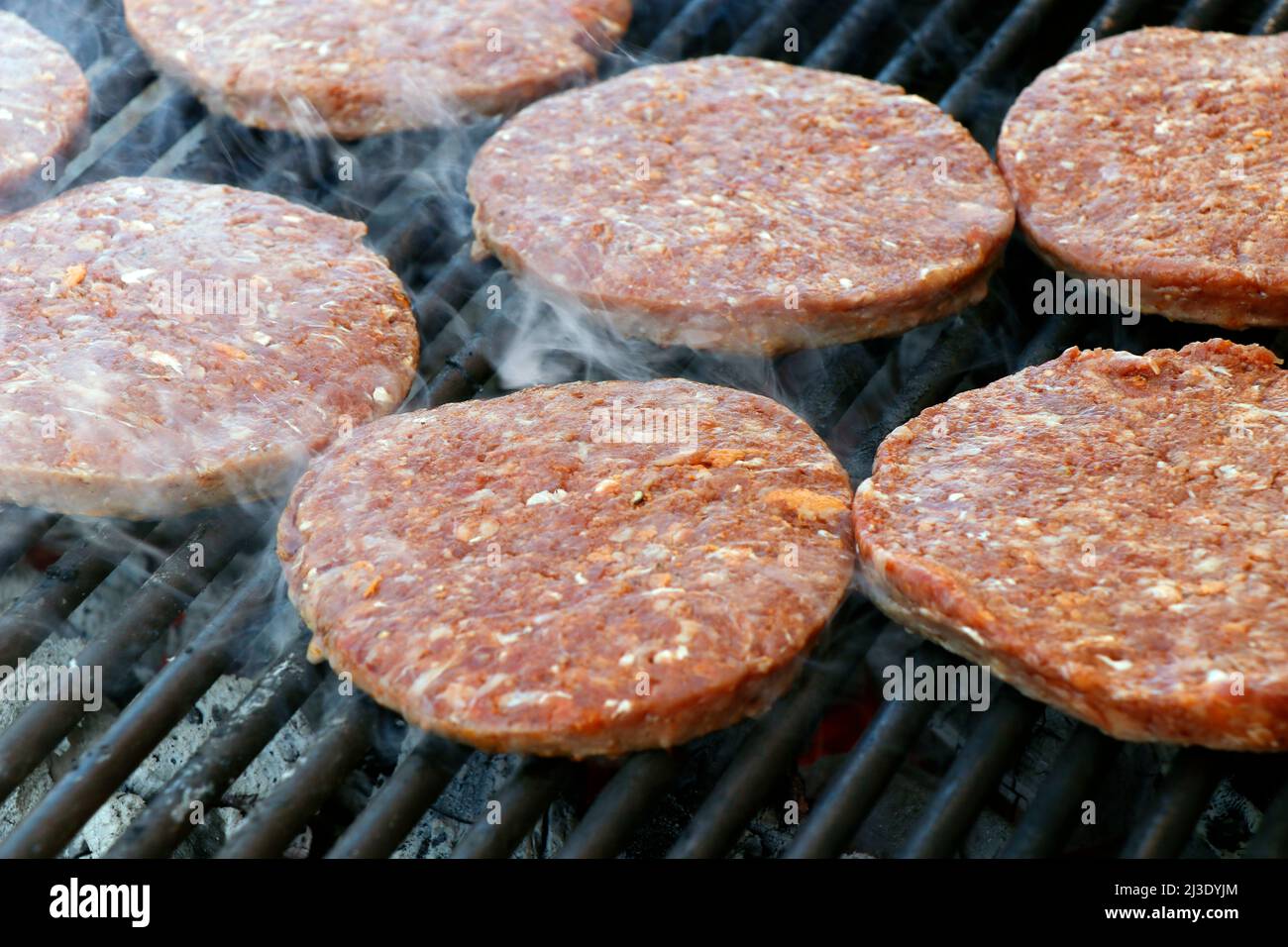 beef meat burger patty on a hot smoky barbeque grill Stock Photo - Alamy