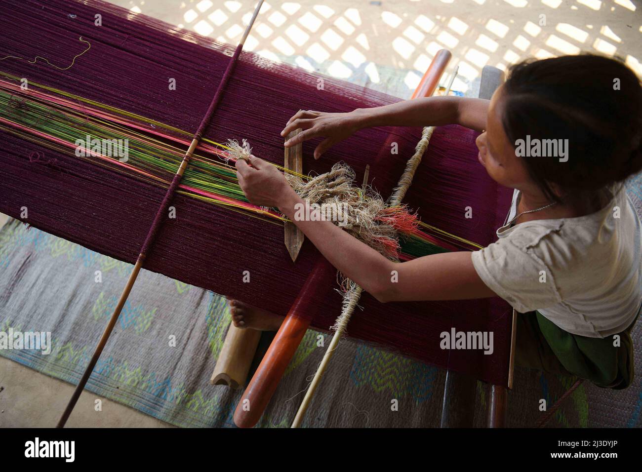 A tribal woman weaving "Rignawi", a traditional cloth used by the ...