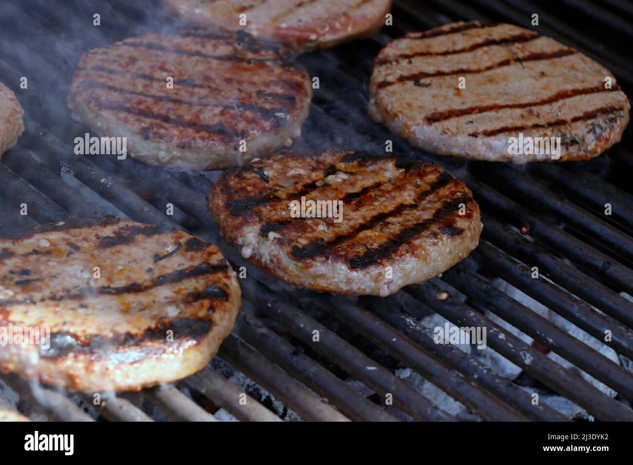 beef meat burger patty on a hot smoky barbeque grill Stock Photo - Alamy