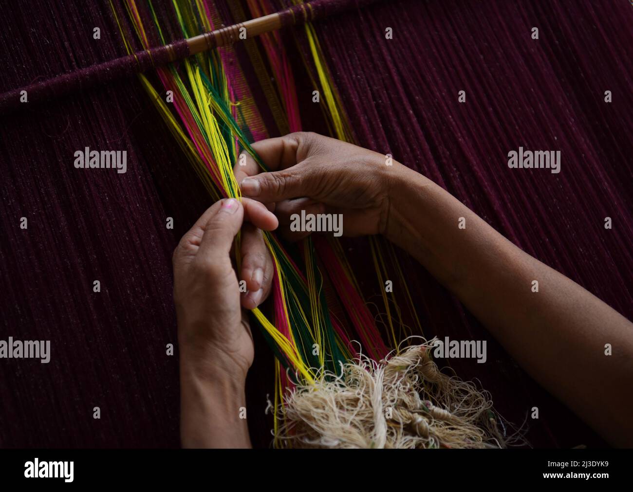 A tribal woman weaving "Rignawi", a traditional cloth used by the ...