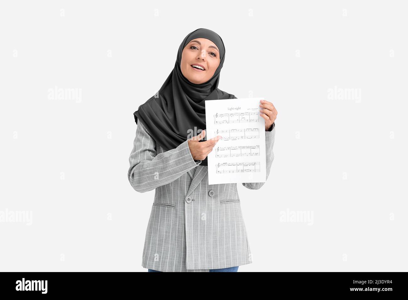 Muslim music teacher with note sheets on light background Stock Photo ...
