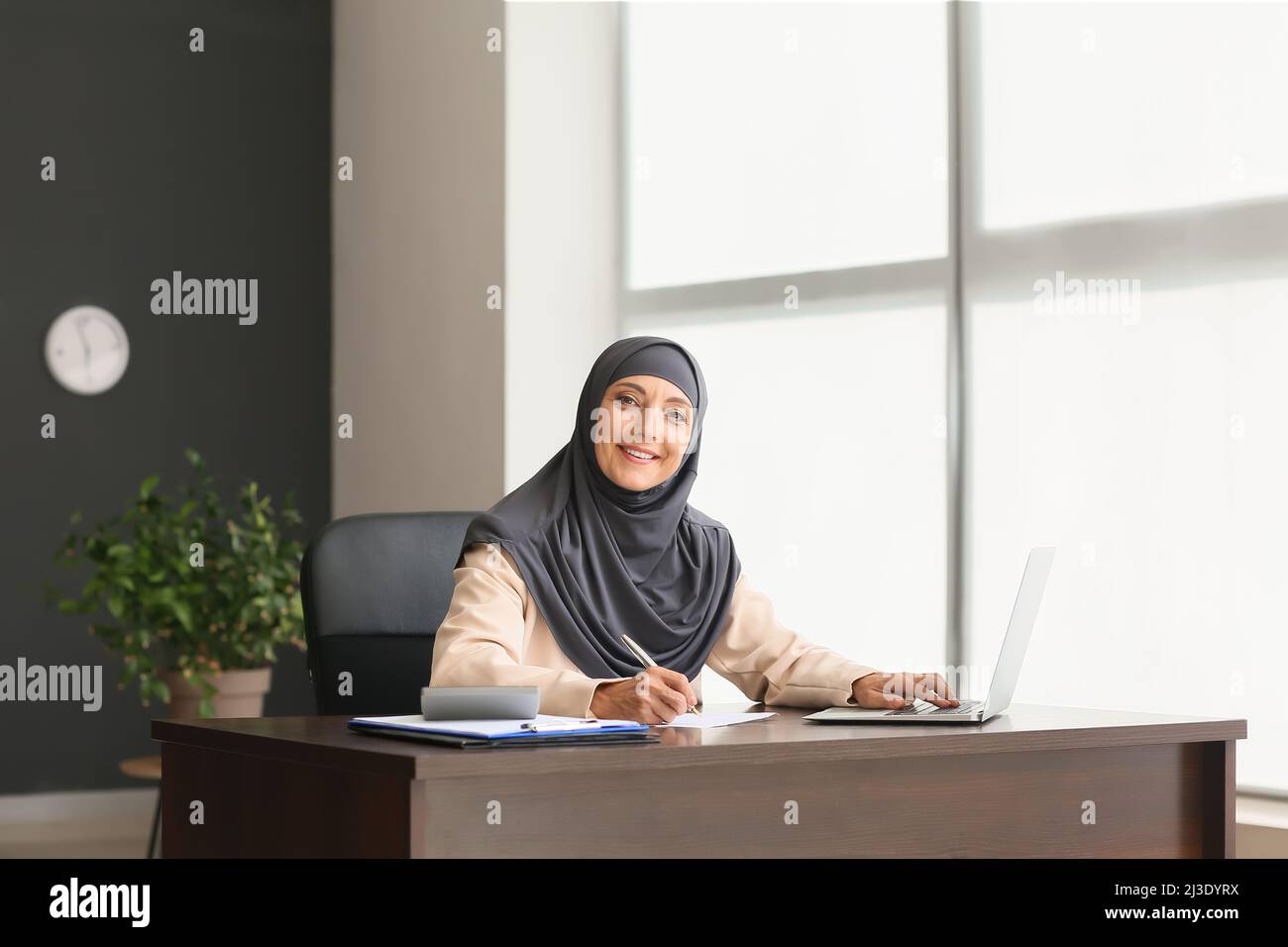 Muslim secretary working in office Stock Photo - Alamy