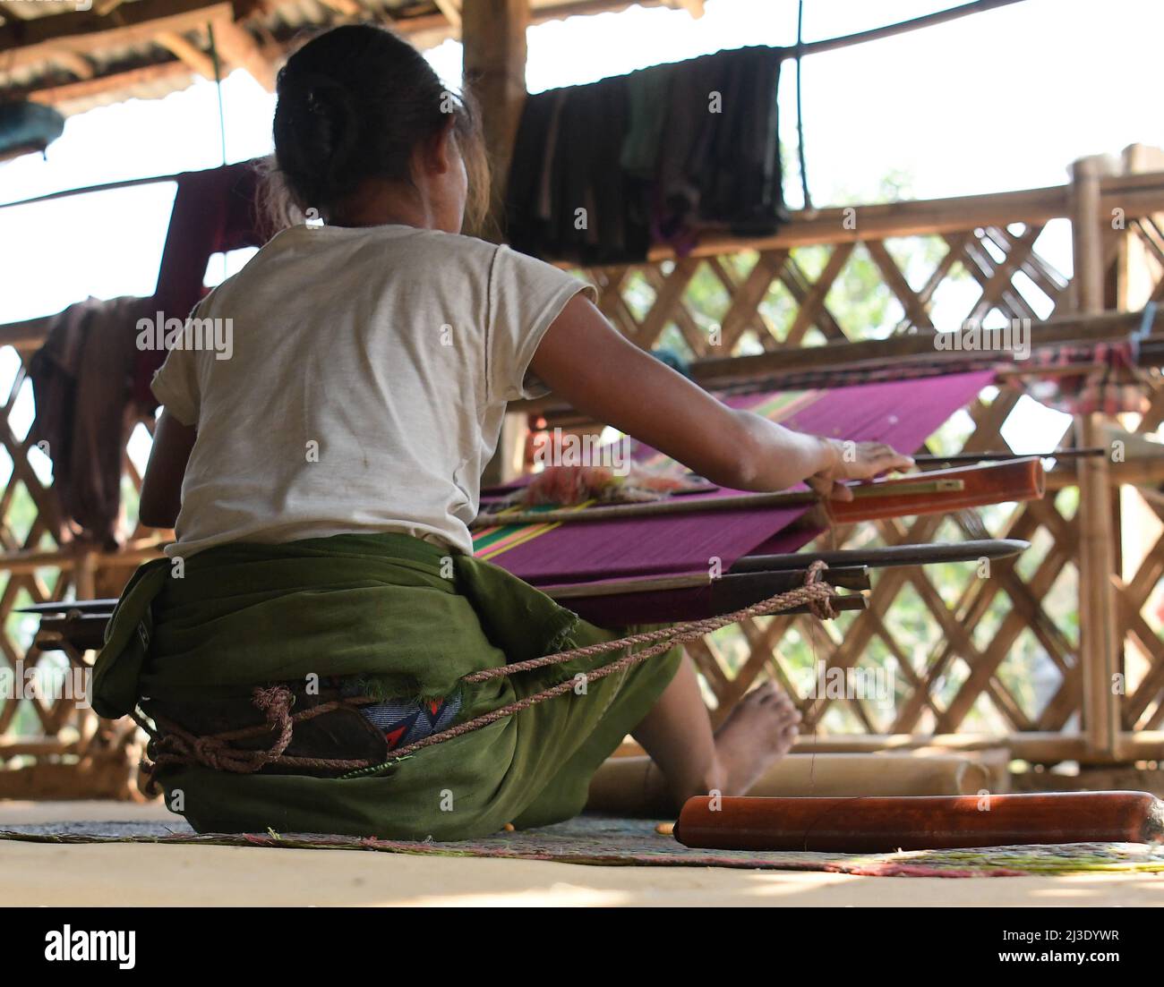 A tribal woman weaving "Rignawi", a traditional cloth used by the ...
