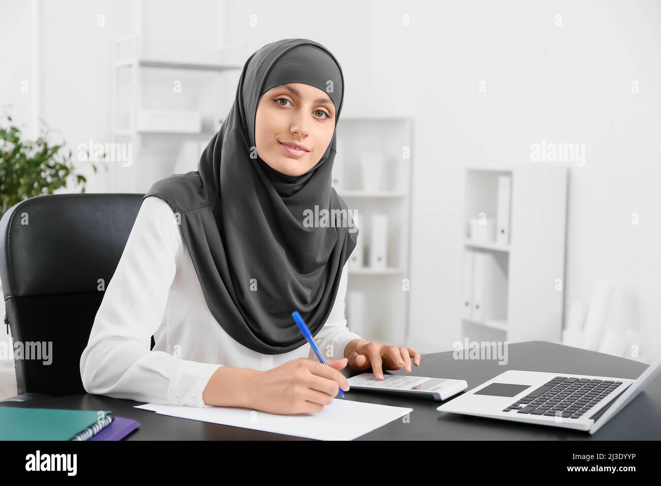 Muslim secretary working in office Stock Photo - Alamy
