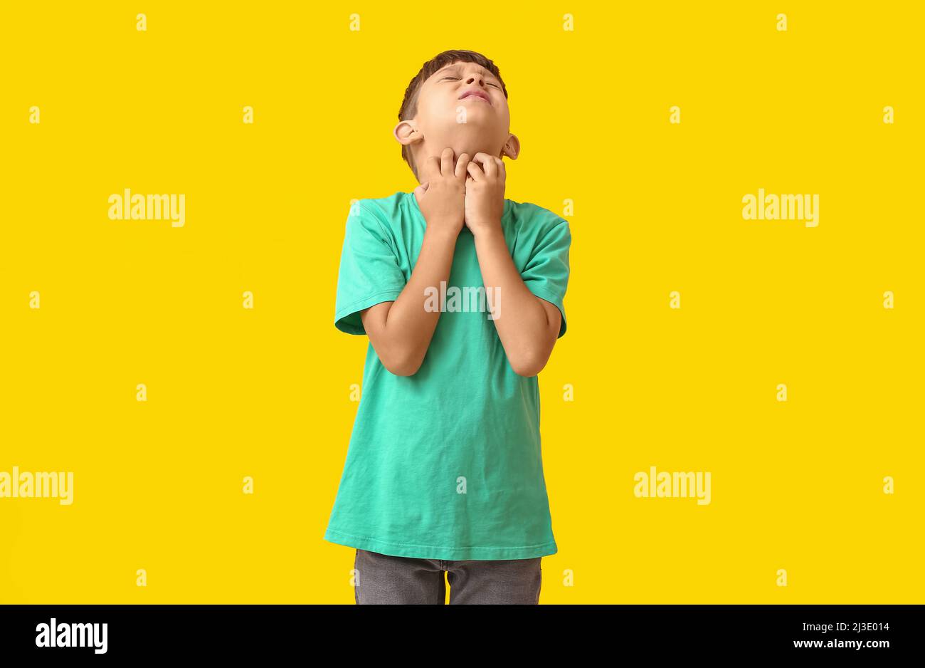 Little boy scratching himself on color background Stock Photo - Alamy