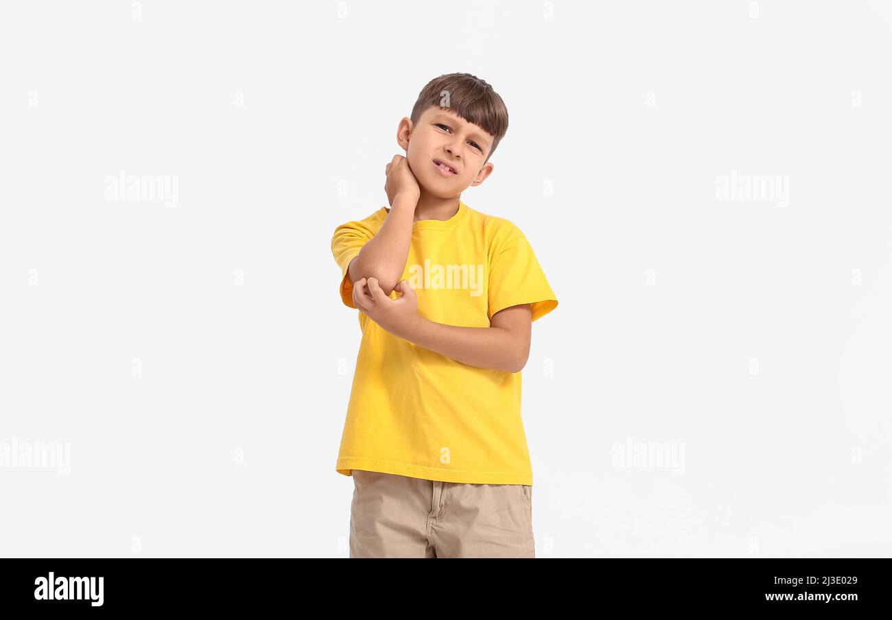 Little boy scratching himself on white background Stock Photo - Alamy