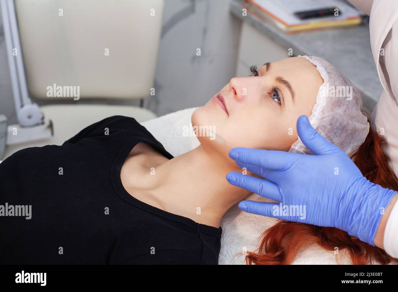 Woman receiving ultrasonic facial massage on ultrasound face machine ...