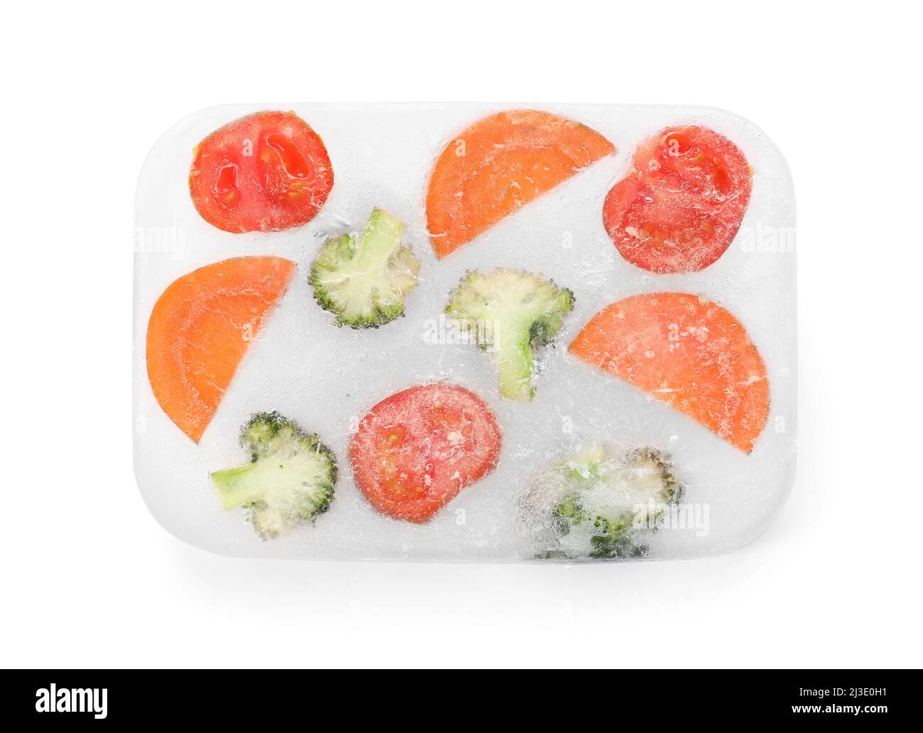 Fresh vegetables frozen in ice on white background Stock Photo - Alamy