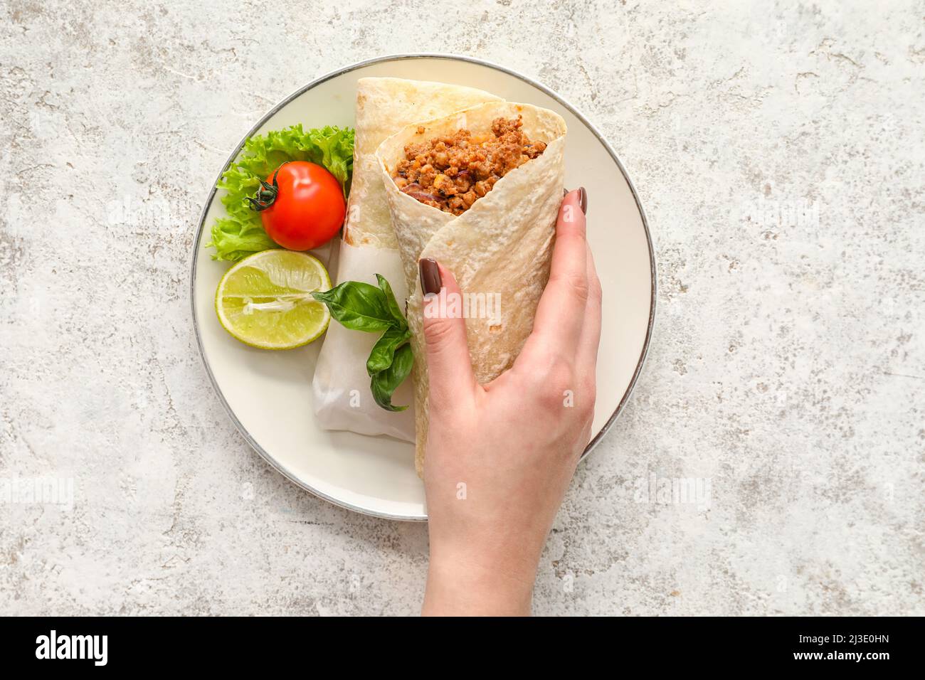 Hand holding burrito hi-res stock photography and images - Alamy