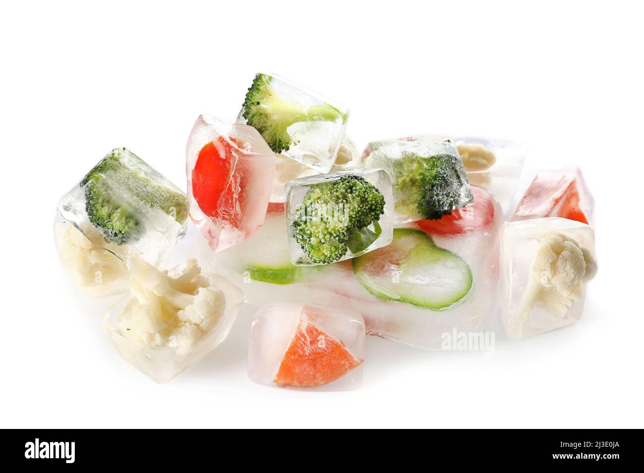 Fresh vegetables frozen in ice on white background Stock Photo - Alamy