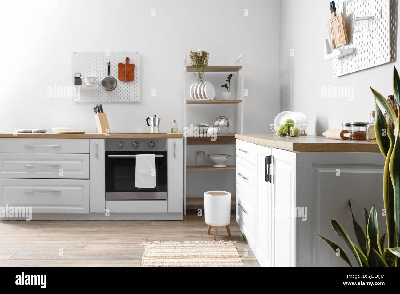 Modern shelving unit with tableware and counters in kitchen Stock Photo ...